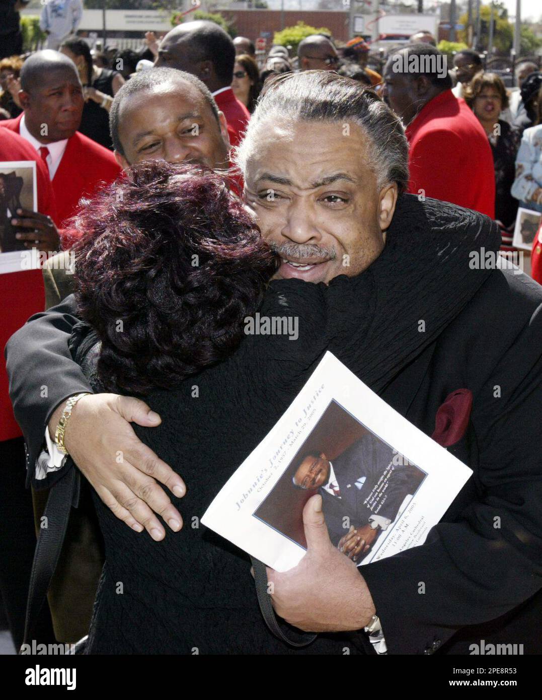 The Rev. Al Sharpton embraces an unidentified woman as he leaves the ...