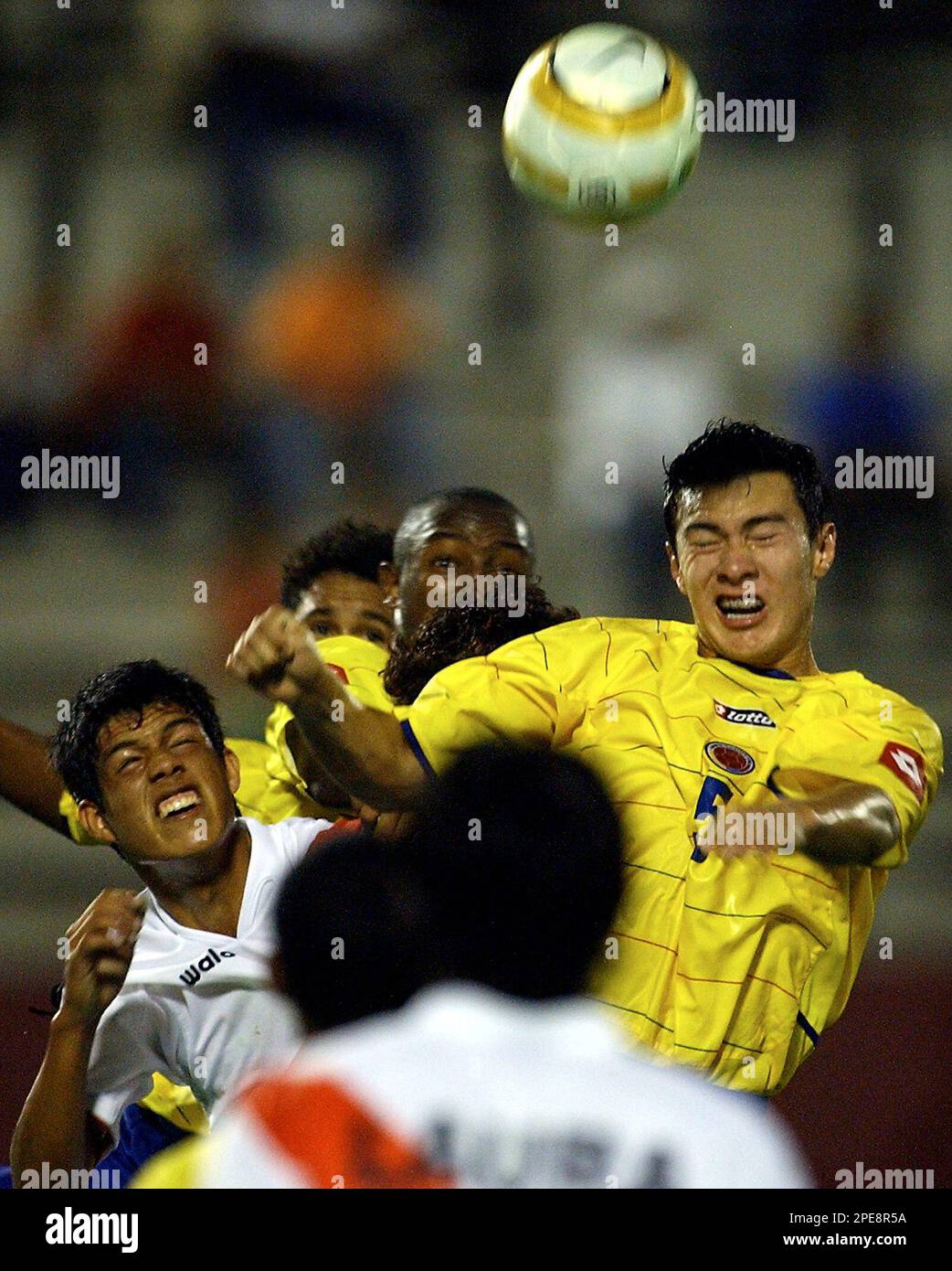 Colombia's Alvaro Leon, right, heads a ball beside Peru's Carlos ...