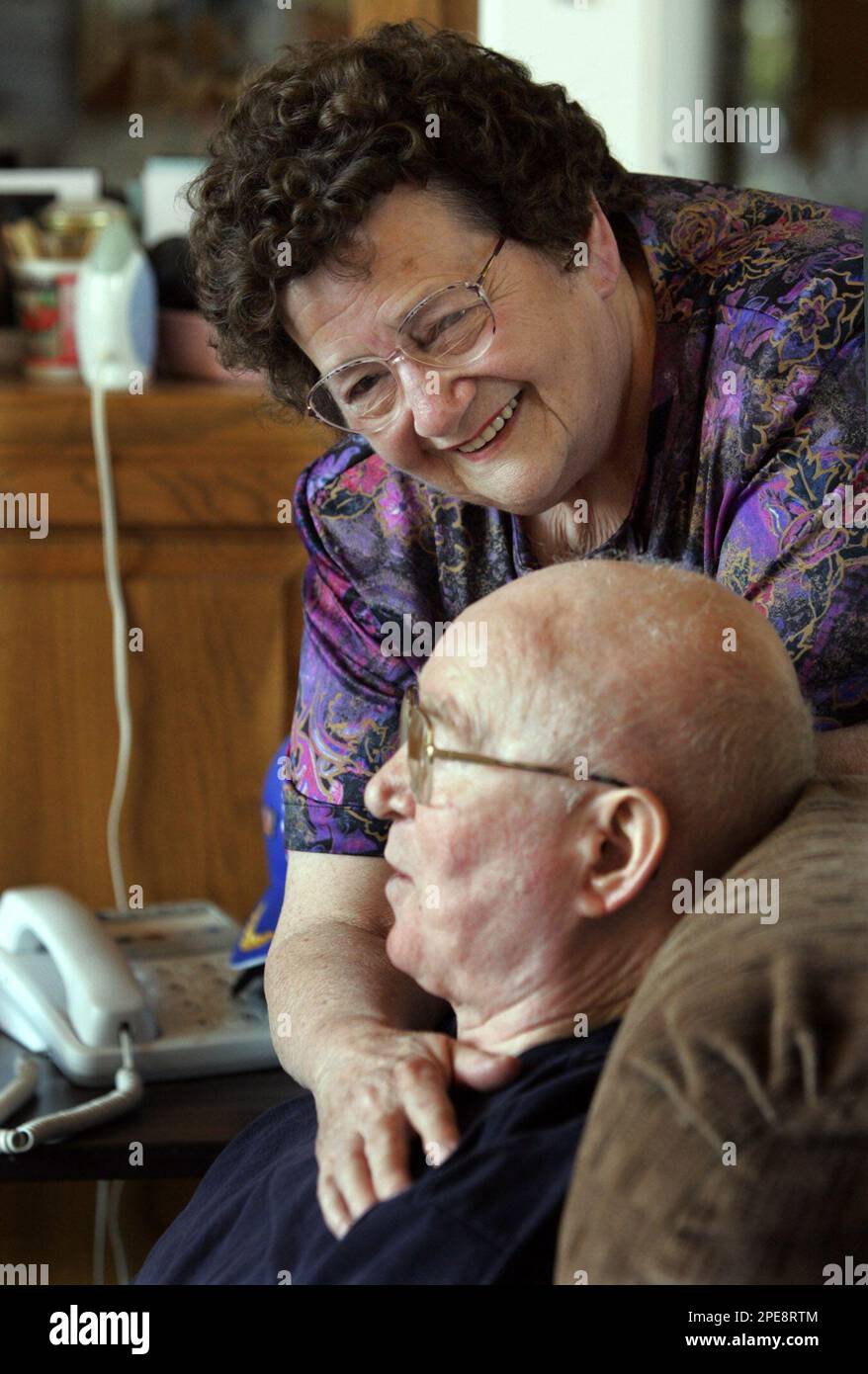 Ruth Sauer smiles as she talks with her husband, Merle, in their home ...