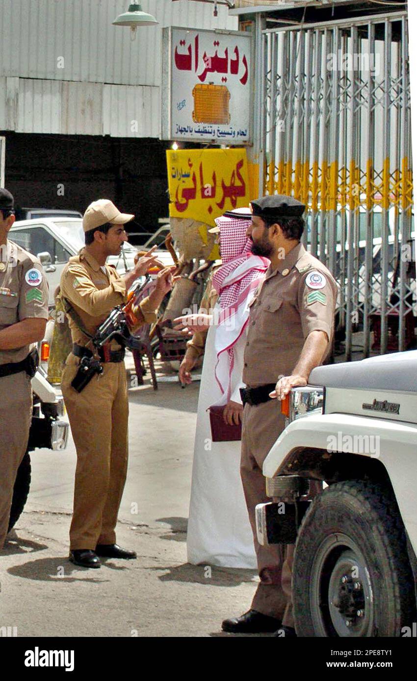 Saudi police officers secure the street after a shootout with militants ...