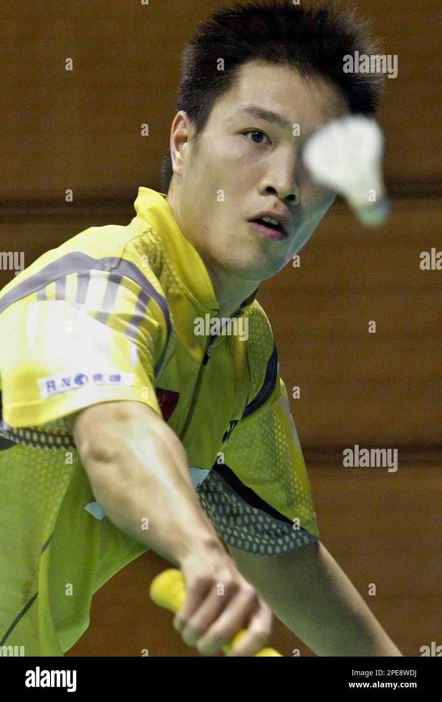 Hong Chen of China eyes the shuttlecock in a match against Nicholas ...