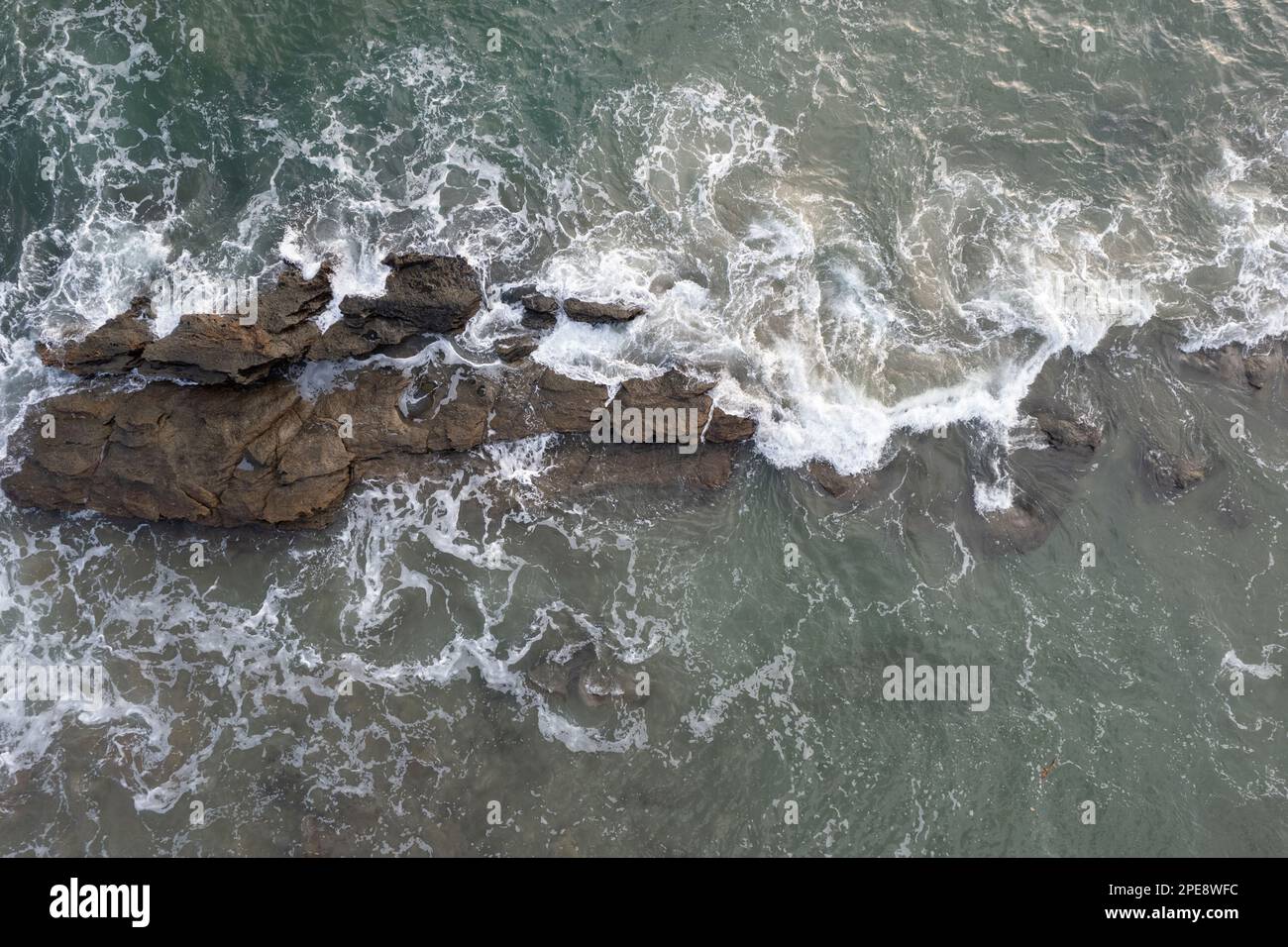 Ocean waves cover stone rock aerial above top view Stock Photo - Alamy