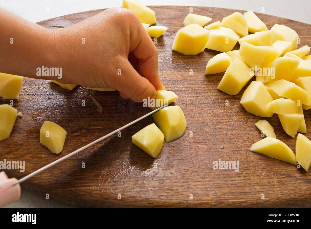 cut the potatoes into pieces Stock Photo - Alamy