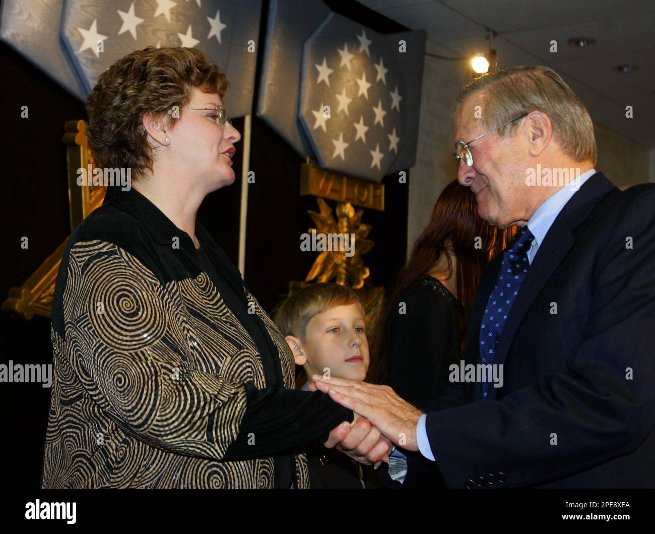 Secretary of Defense Donald Rumsfeld, right, takes the hand of Birgit ...