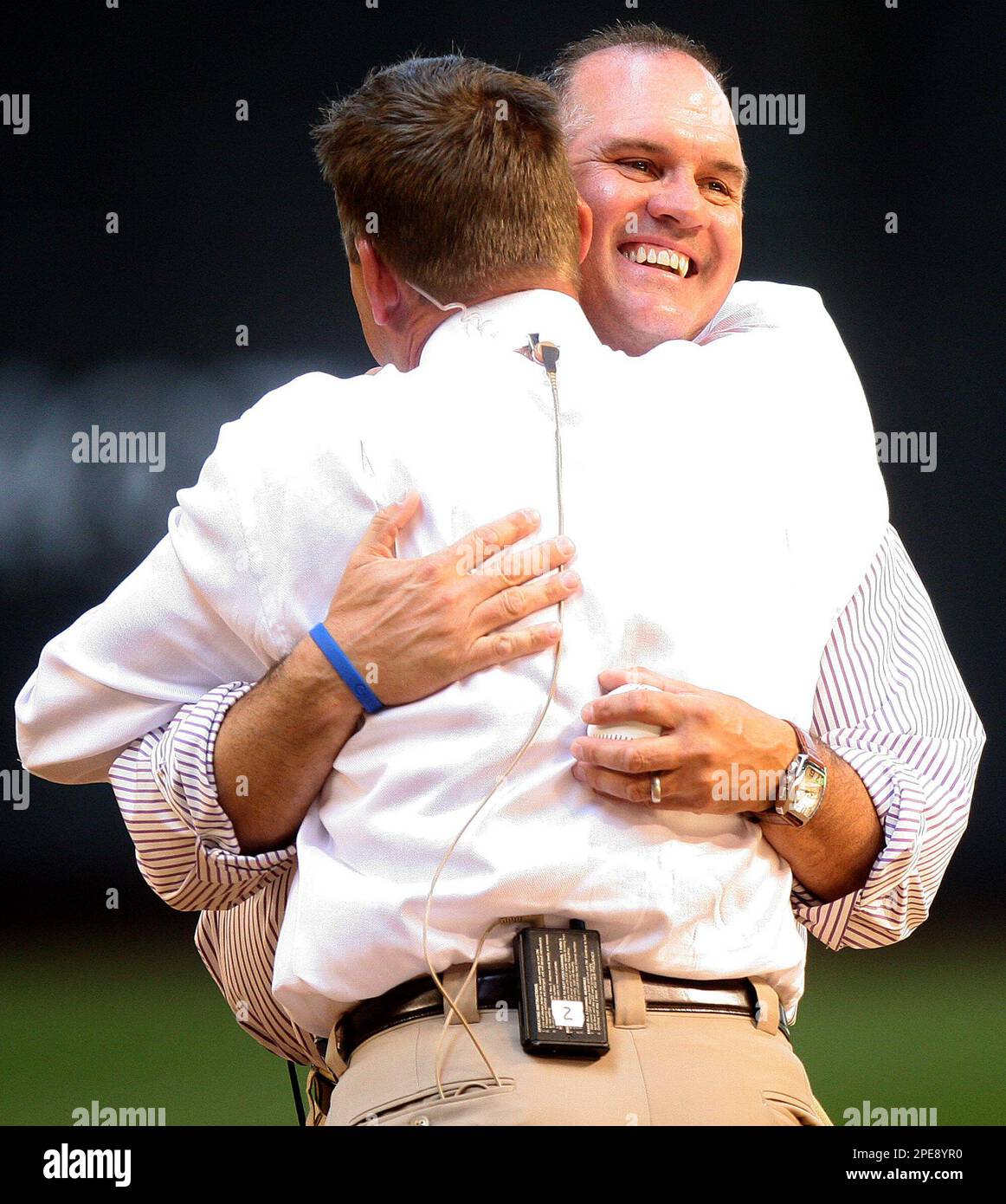 Former Chicago Cubs players Ryne Sandberg, right, hugs Mark Grace after ...