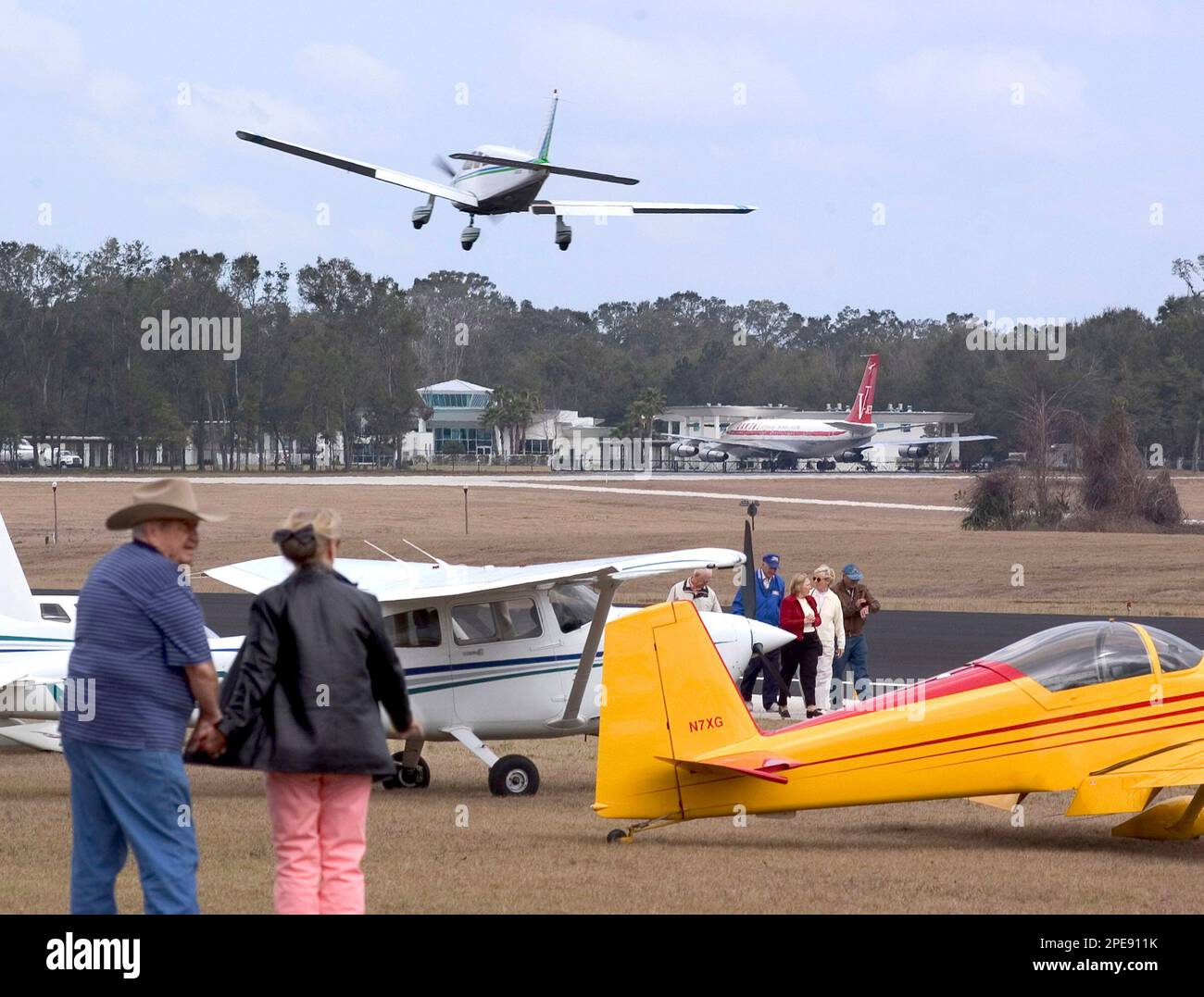 Guests leave their planes to attend an invitation-only brunch hosted by ...