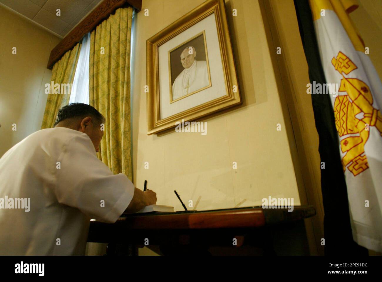 Filipino Roman Catholic Bishop Camilo Gregorio signs the Condolence ...