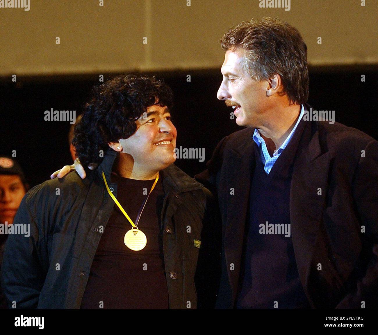 Former soccer player Diego Maradona, left, talks with Boca Juniors ...