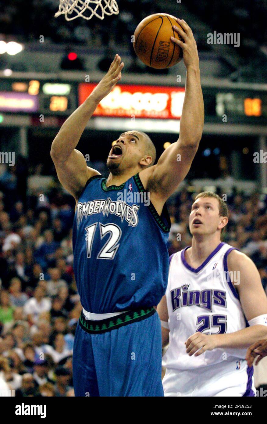 Minnesota Timberwolves center John Thomas, left, gets to the basket ...