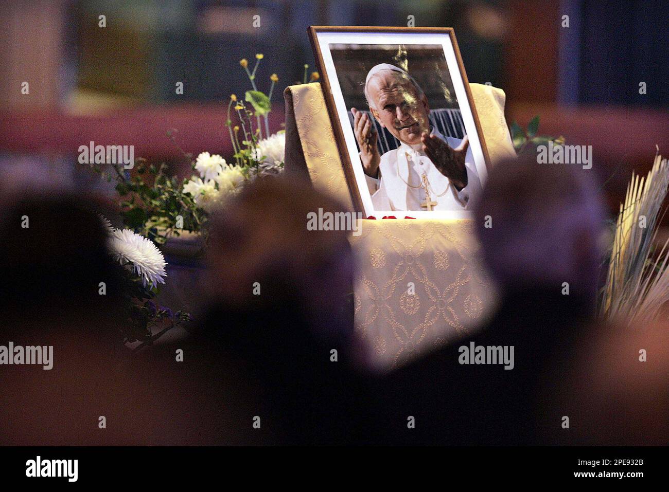 A portrait of the Pope stands on the altar as Catholic Archbishop of ...