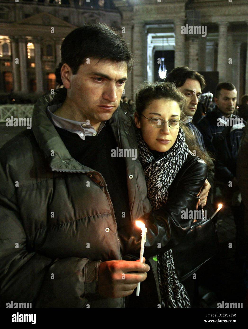 People hold candles during a vigil in St. Peter's Square at the Vatican ...