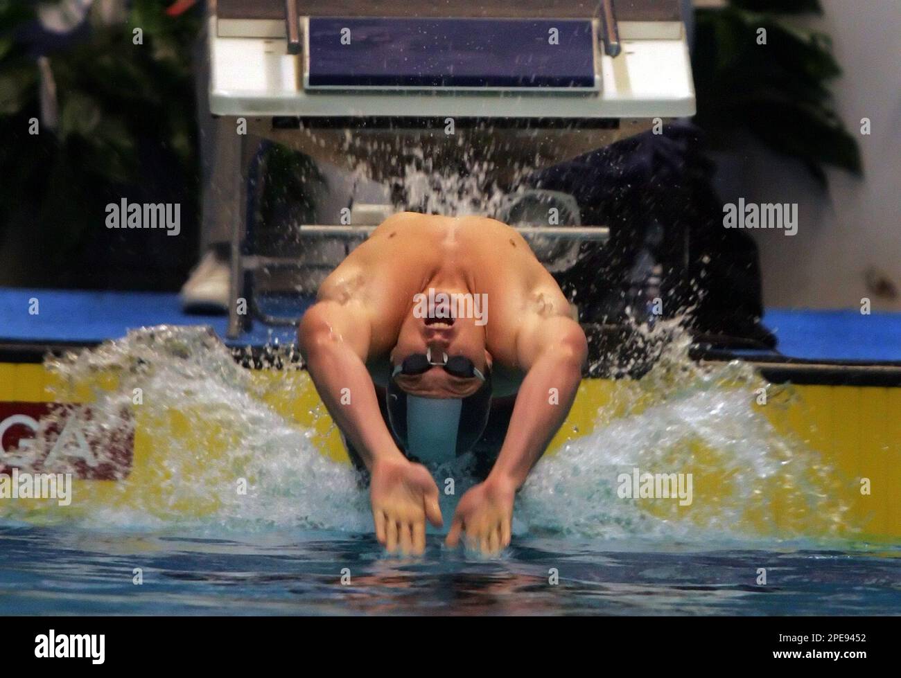 Aaron Peirsol launches to start the 100-meter backstroke during the ...