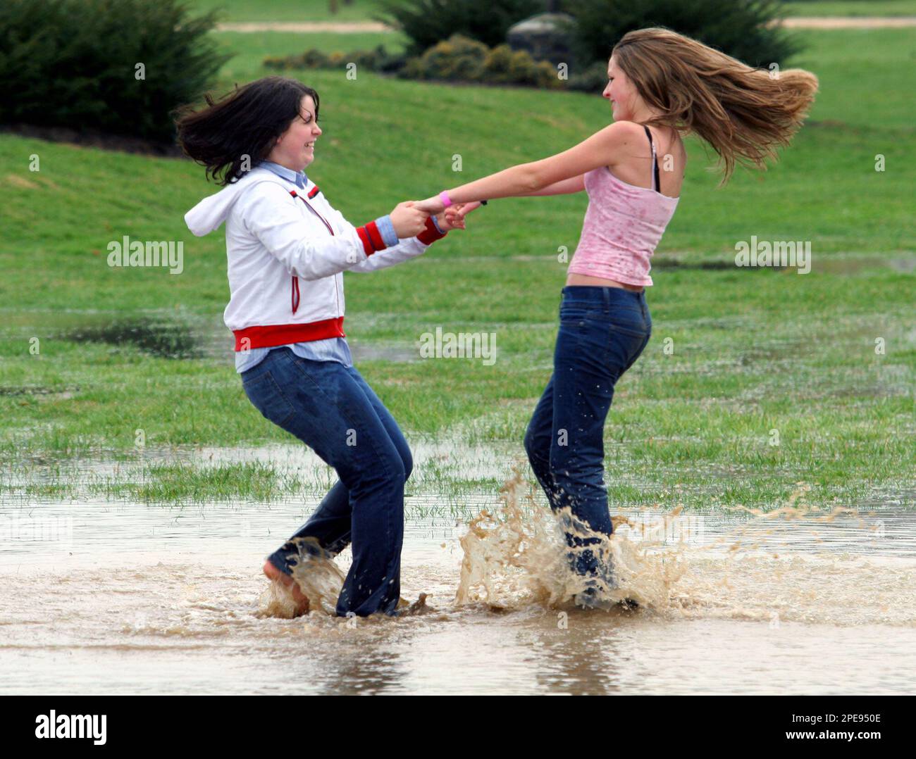 Chelsea Resch, 15, left, and Emily Rother, 15, dance in flood waters ...