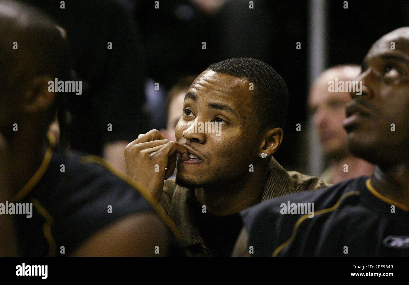 Seattle SuperSonics forward Rashard Lewis, center, sits behind the ...