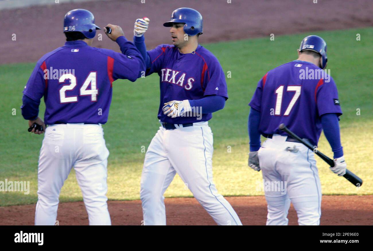 Texas Rangers' Rod Barajas, middle, is congratulated by Adrian Gonzalez ...