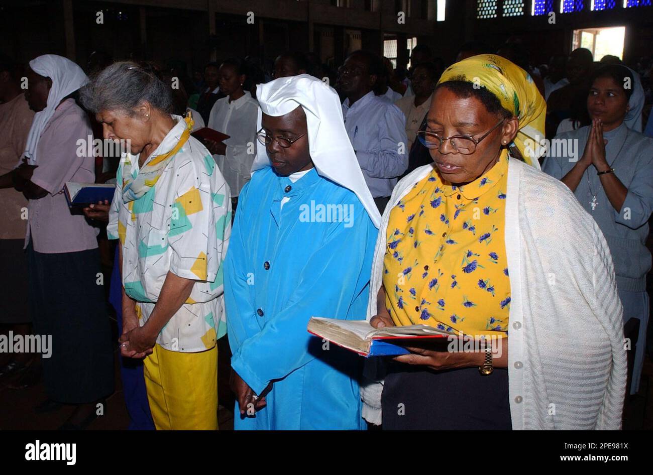 Kenyan joins in prayers at Holy Family Cathedral Nairobi. Friday, April ...