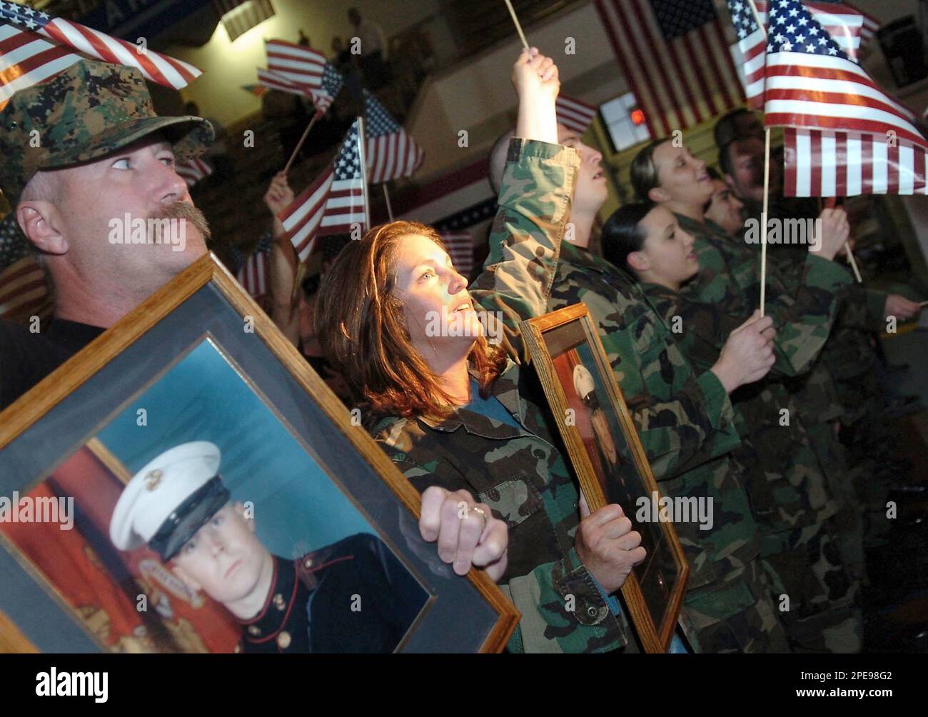 Phil Lugenbill, left and his wife Elizabeth hold up pictures of their ...