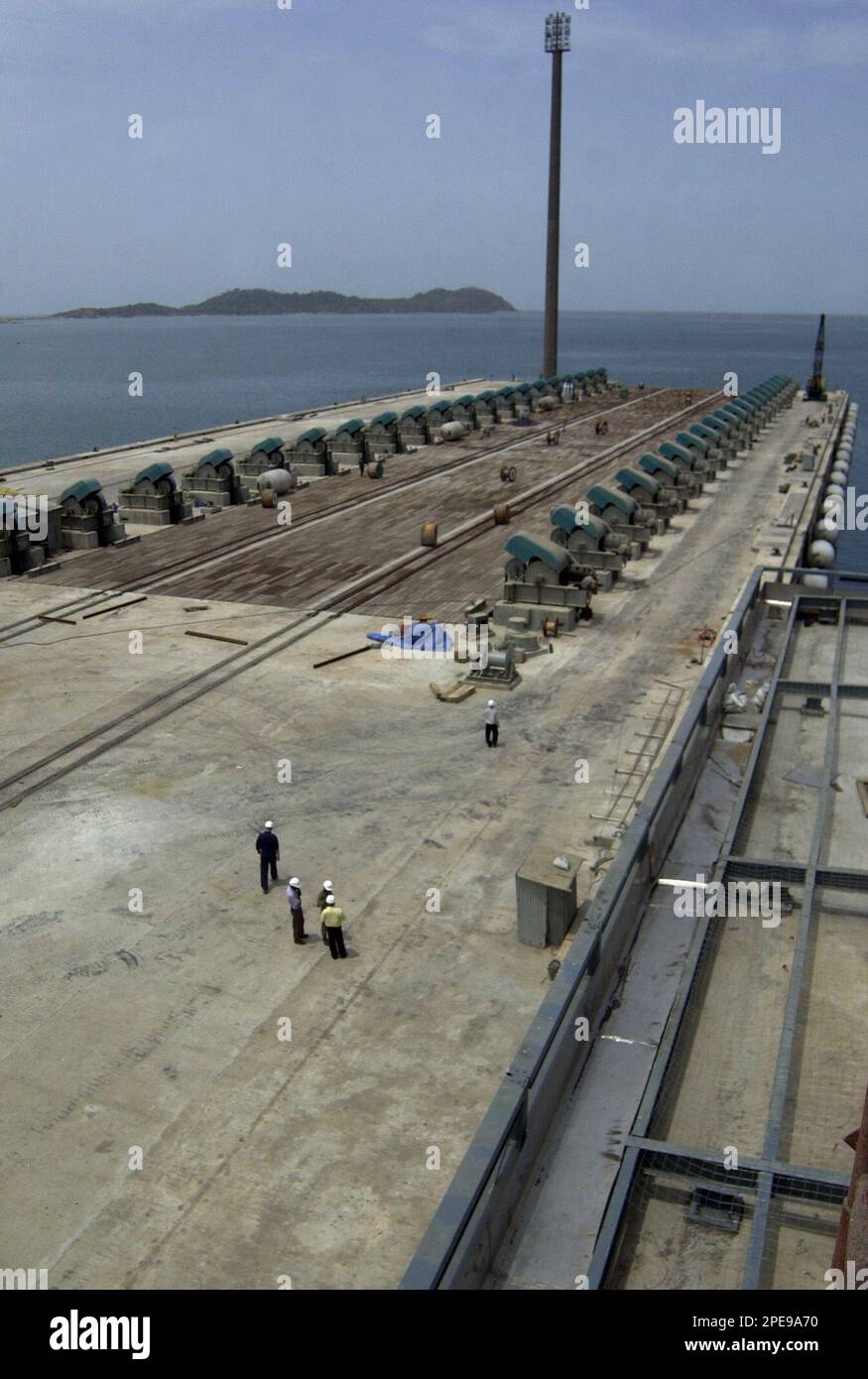 Workers are seen on a shiplift at Karwar Naval Base, about 105 ...
