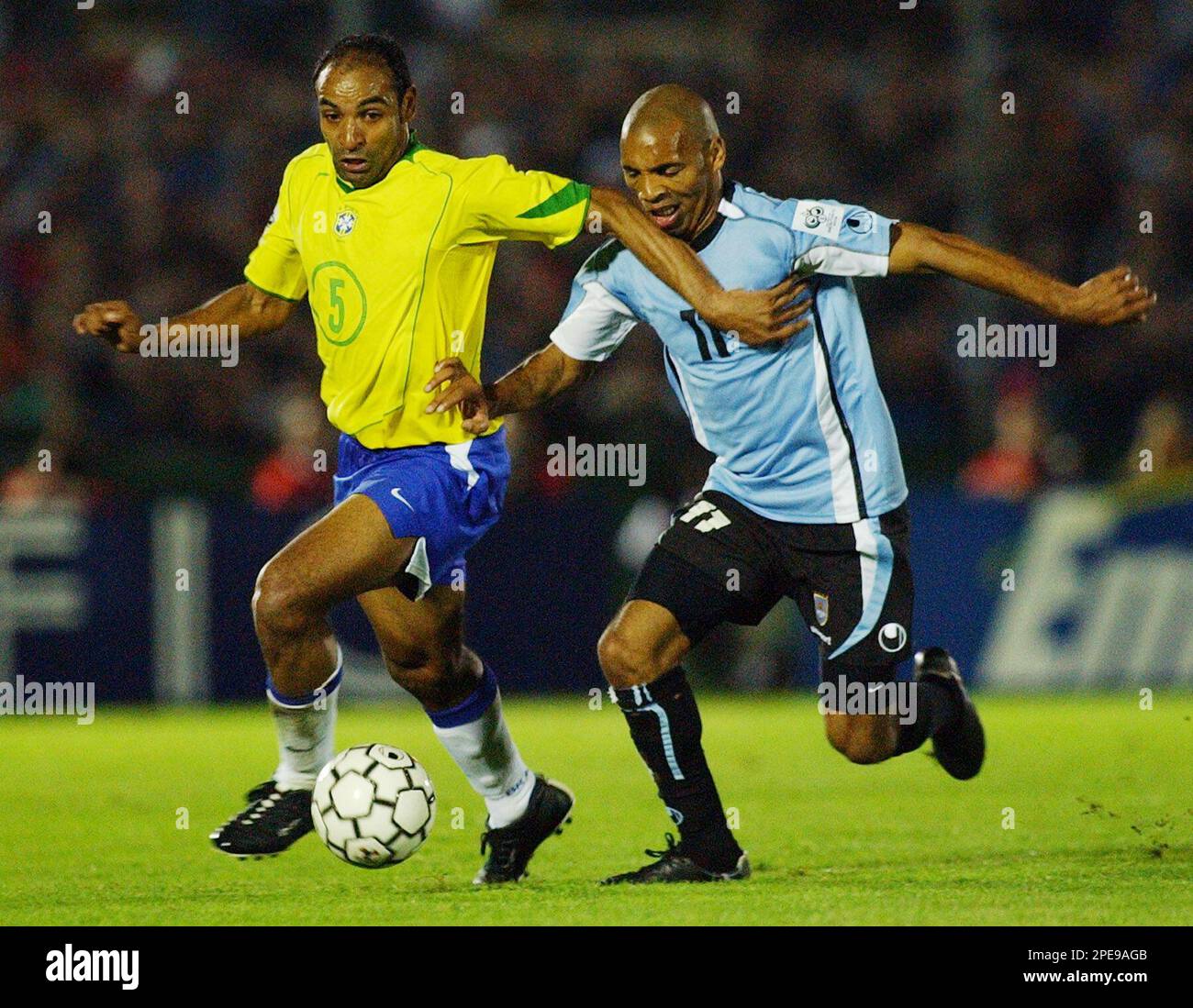 Brazilian Emerson struggles for the ball against Uruguay's Mario ...