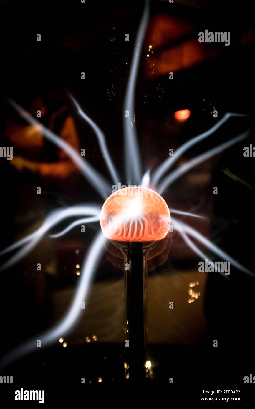 Energy lightning rays from an orange core sphere Stock Photo - Alamy