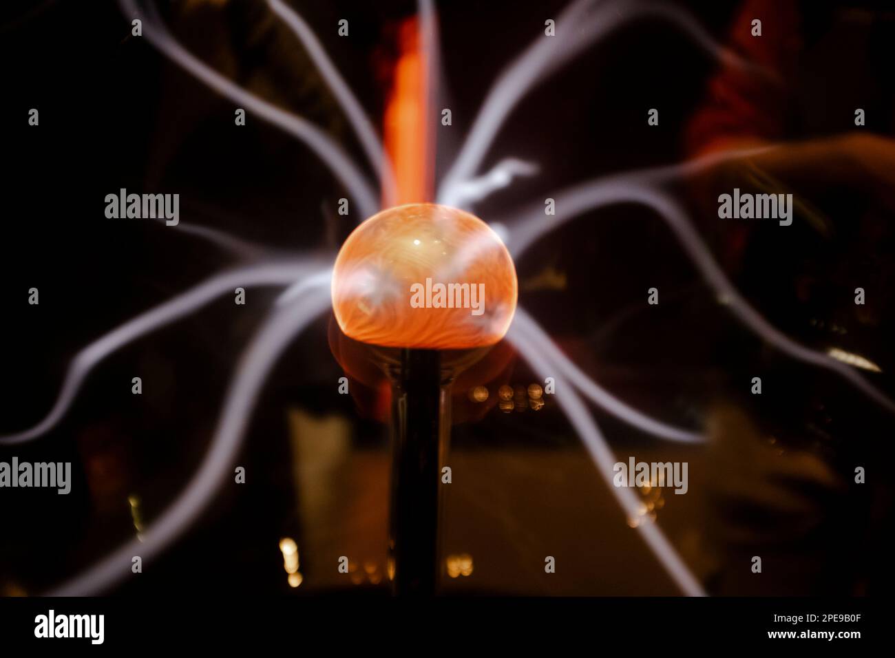 Energy lightning rays from an orange core sphere Stock Photo - Alamy