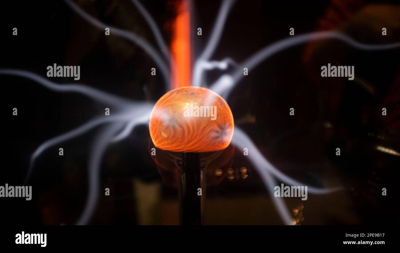 Energy lightning rays from an orange core sphere Stock Photo - Alamy