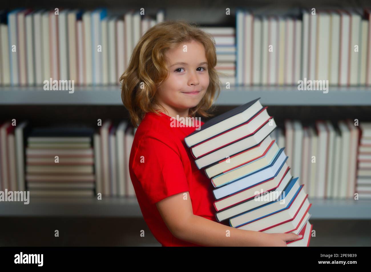 Pupil with book. Schoolboy reading book in library. Kids learn to read ...