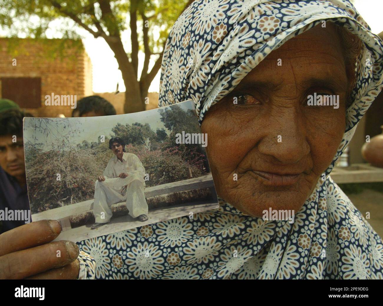 Jannat Bibi shows a picture of her son Bashir Ahmad, Tuesday March 29 ...