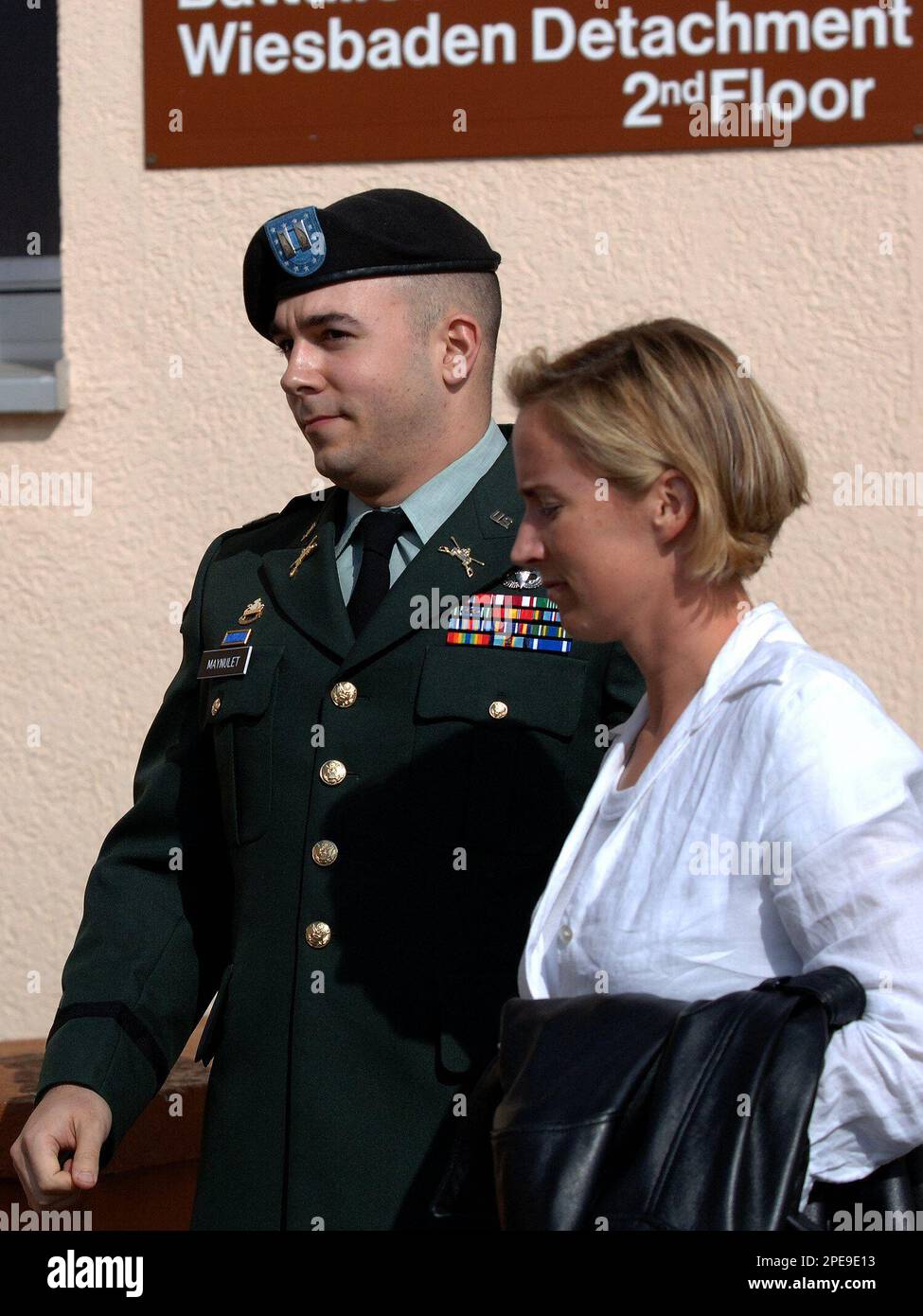 US Army Capt. Rogelio M. Maynulet, left, and his wife Brooke leave the ...