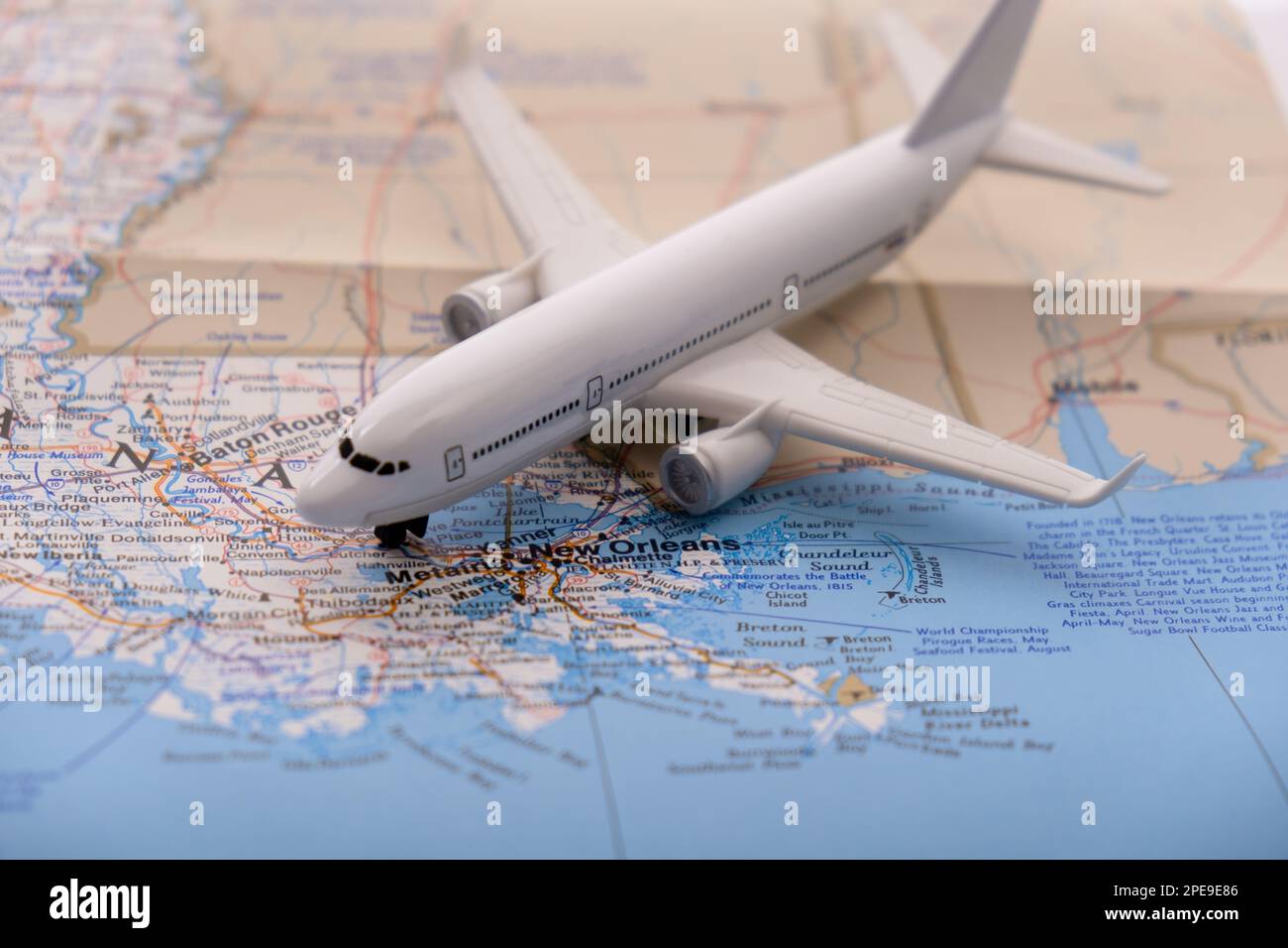 Close up detail of a miniature passenger airplane on a colorful map ...