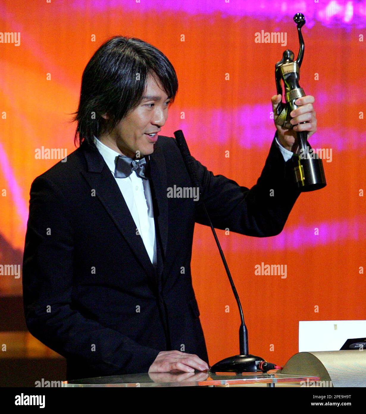 Hong Kong Director Stephen Chow holds up his award for Best Film for ...