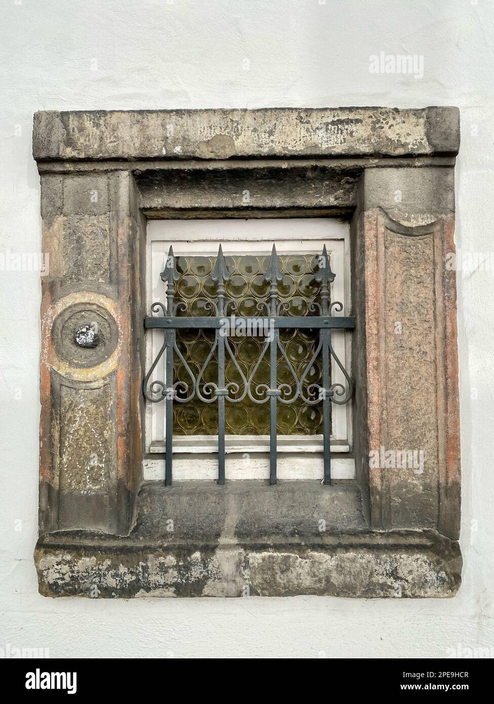 Old window in the historic city wall of Paderborn. The decorated iron ...