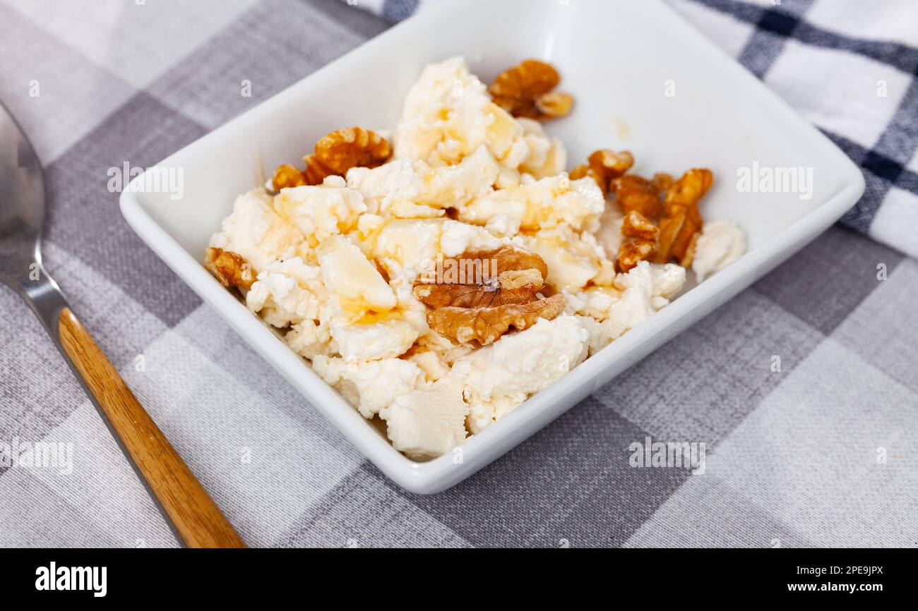 Fresh cottage cheese with honey and walnuts Stock Photo - Alamy
