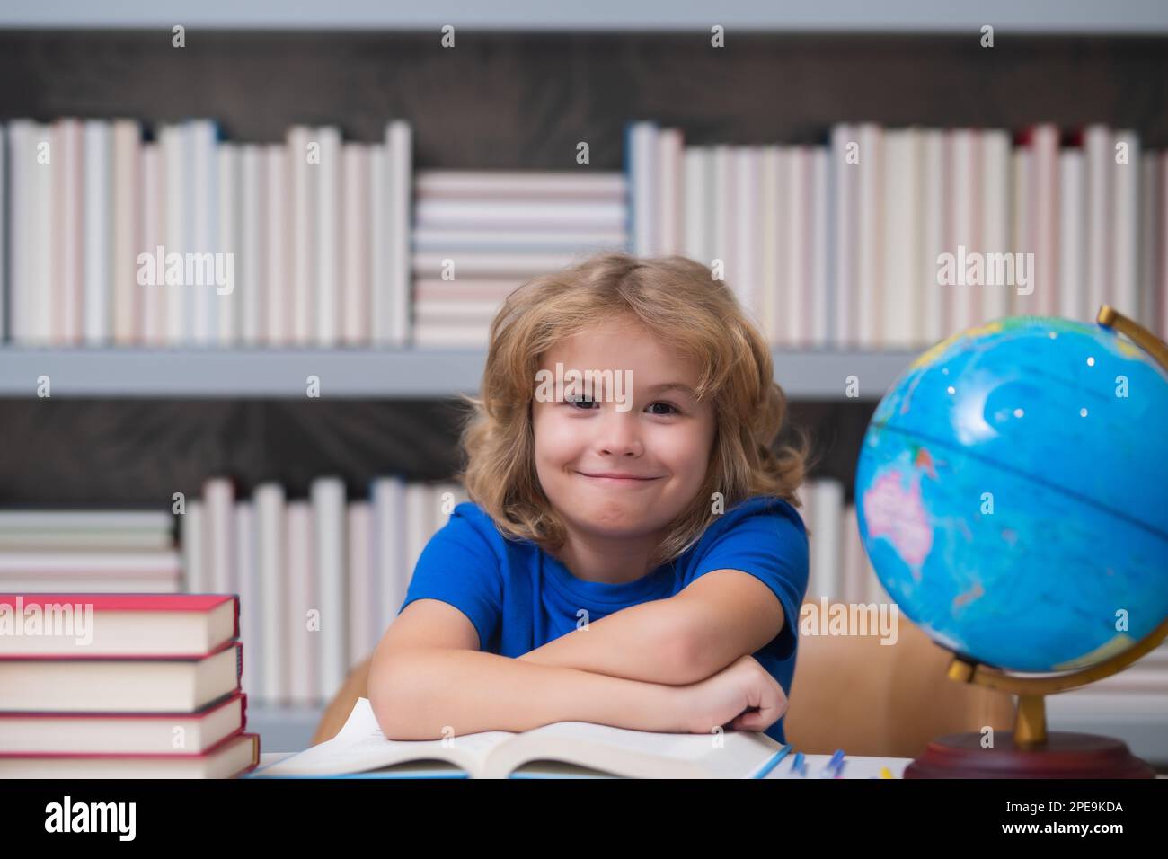Little student read book. School child studying in school library. Kid ...