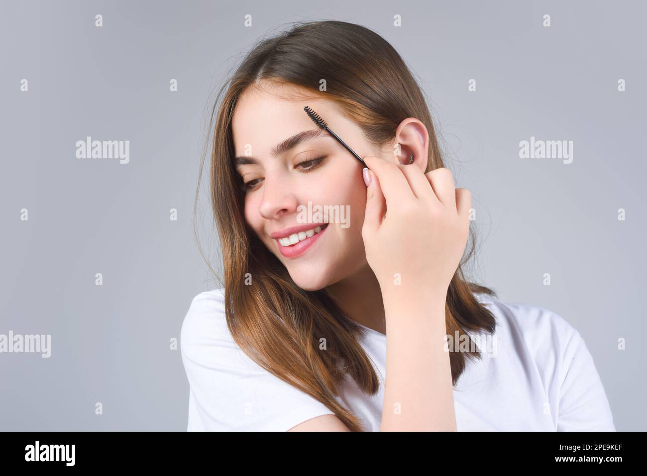 Eyebrow shaping, woman combs eyebrows with a brus. Eyebrow line. Makeup ...