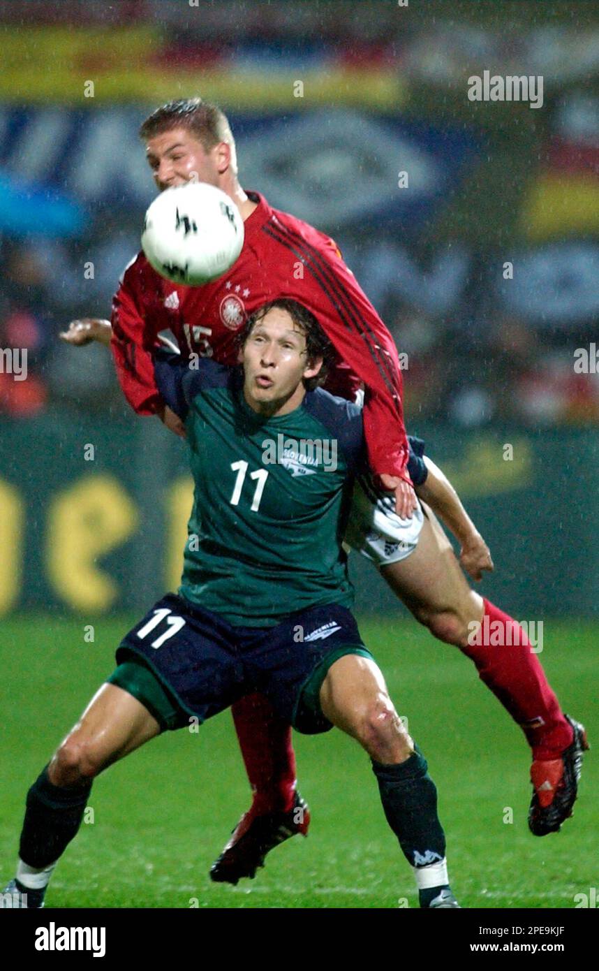 Thomas Hitzlsperger of Germany, top, and Andrej Komac of Slovenia ...
