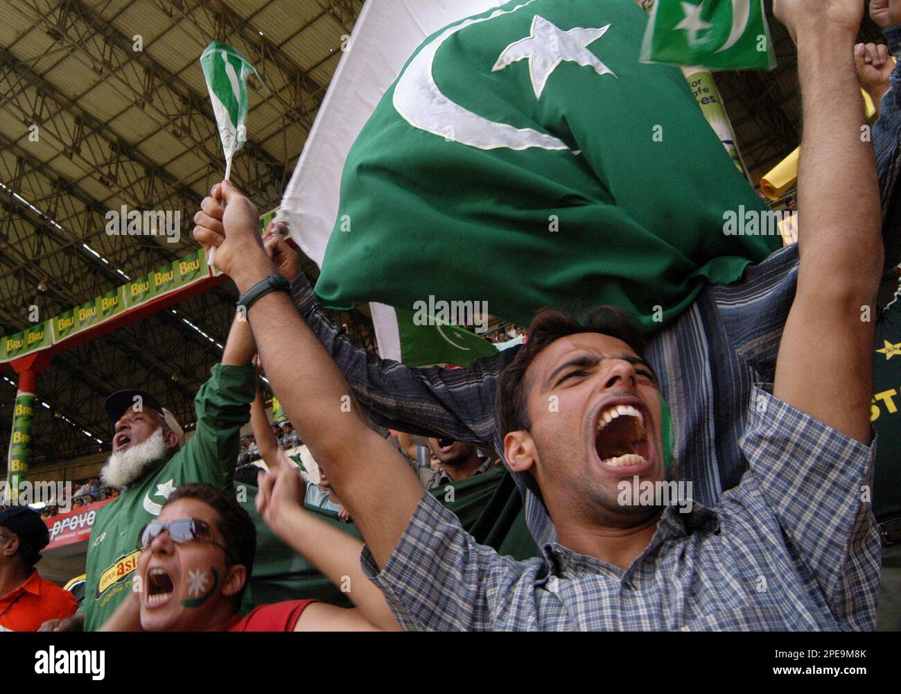 Pakistani cricket fan from Lahore Mohammed Amir Butt, right, 24, waves ...