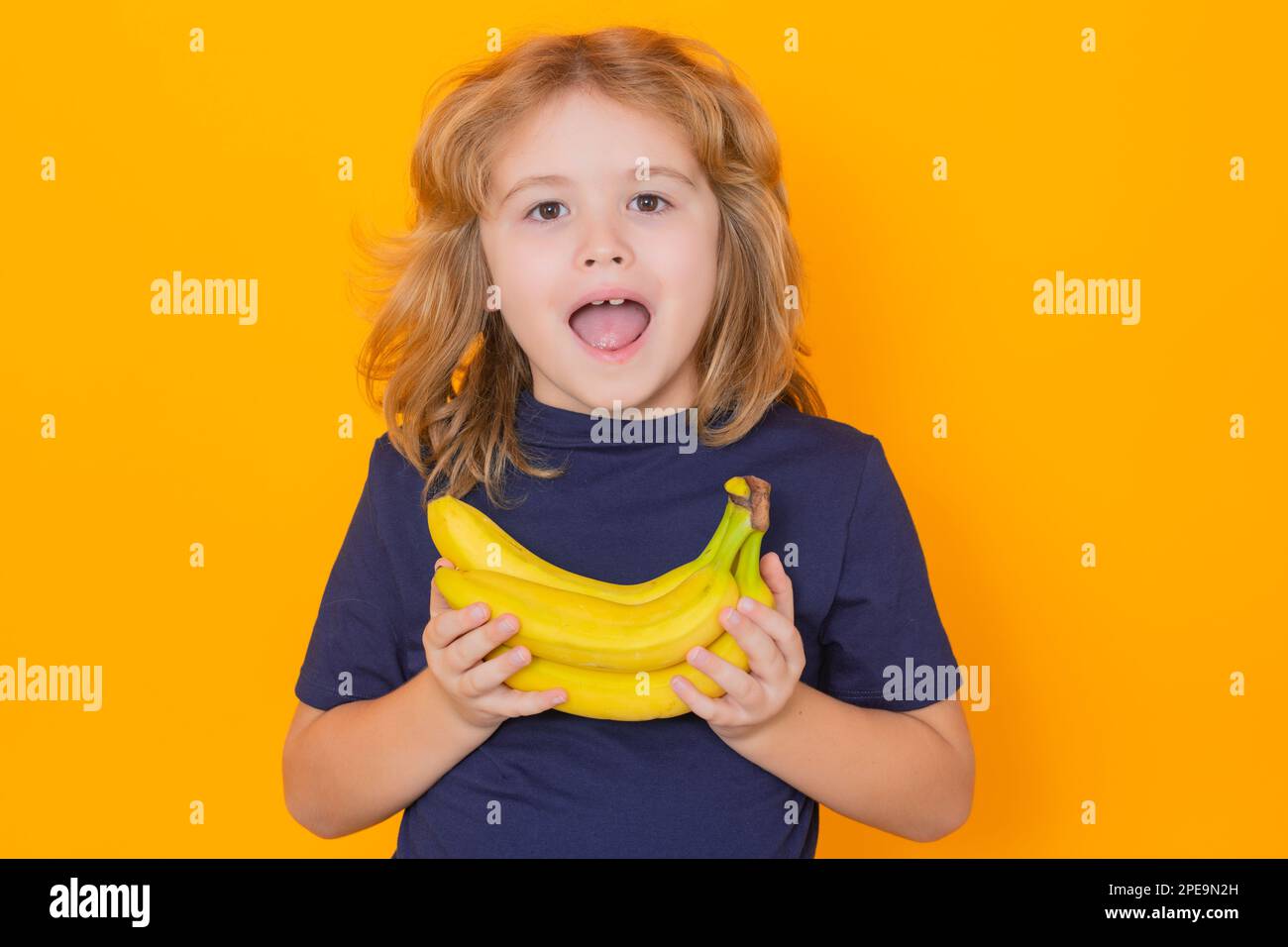 Vitamin and healthy fruits for kids. Child hold banana in studio ...
