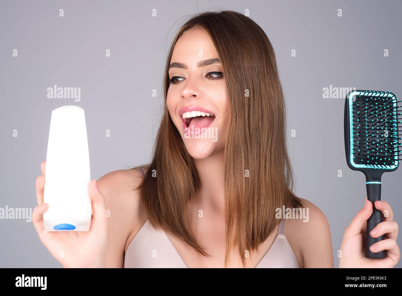 Close up photo of beautiful woman hold bottle shampoo with hair growth ...