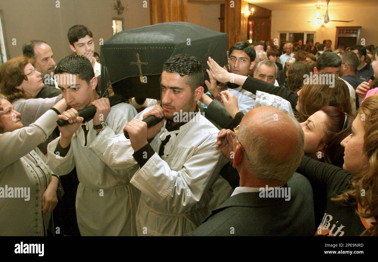 Worshippers reach for a casket symbolizing Jesus during Good Friday ...