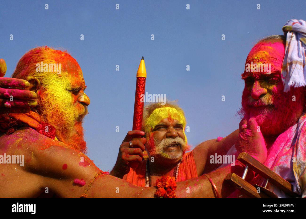 Hindu Sadhus or holy men smear each other with color on the Sangam, the ...