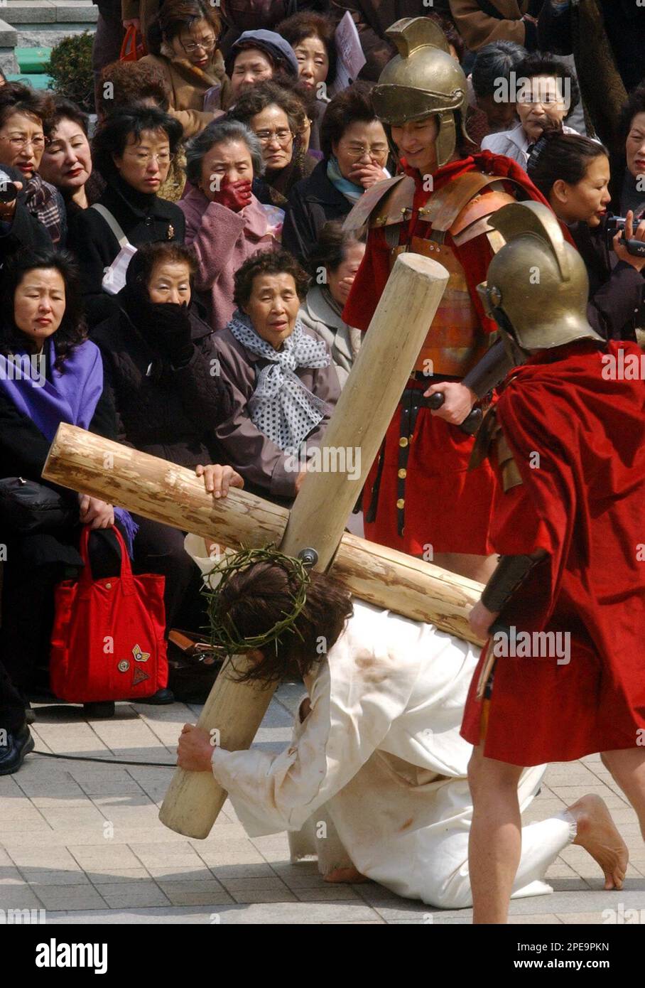 South Korean Christian actor Chung Sun-il carries a cross while ...