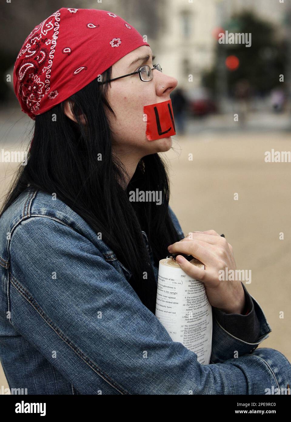 Rebecca Gatlyn, 19, a member of the group 'The Cause USA,' prays with a ...