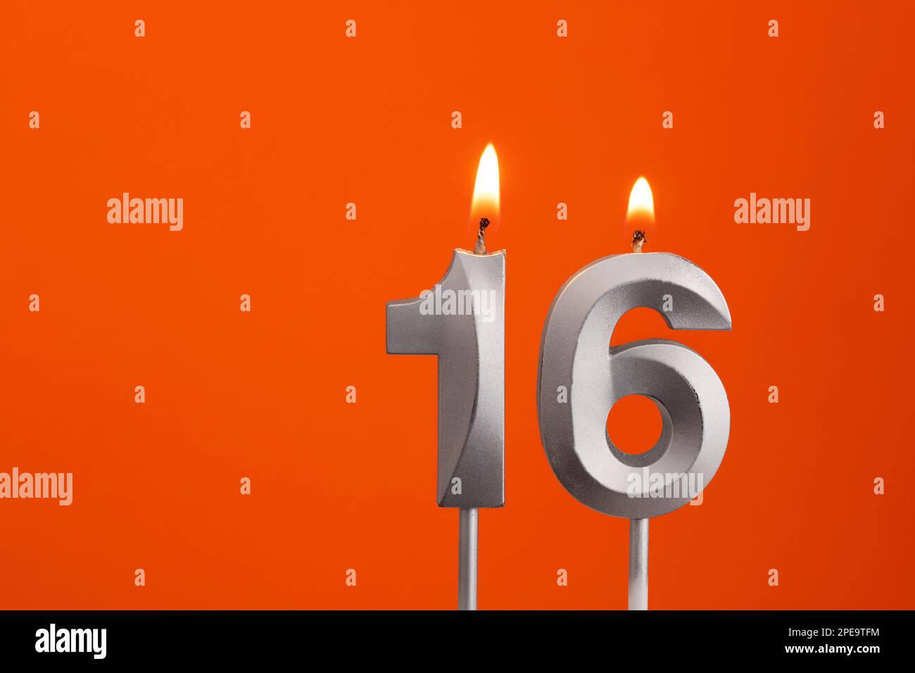 Candle number 16 - Birthday in orange background Stock Photo - Alamy