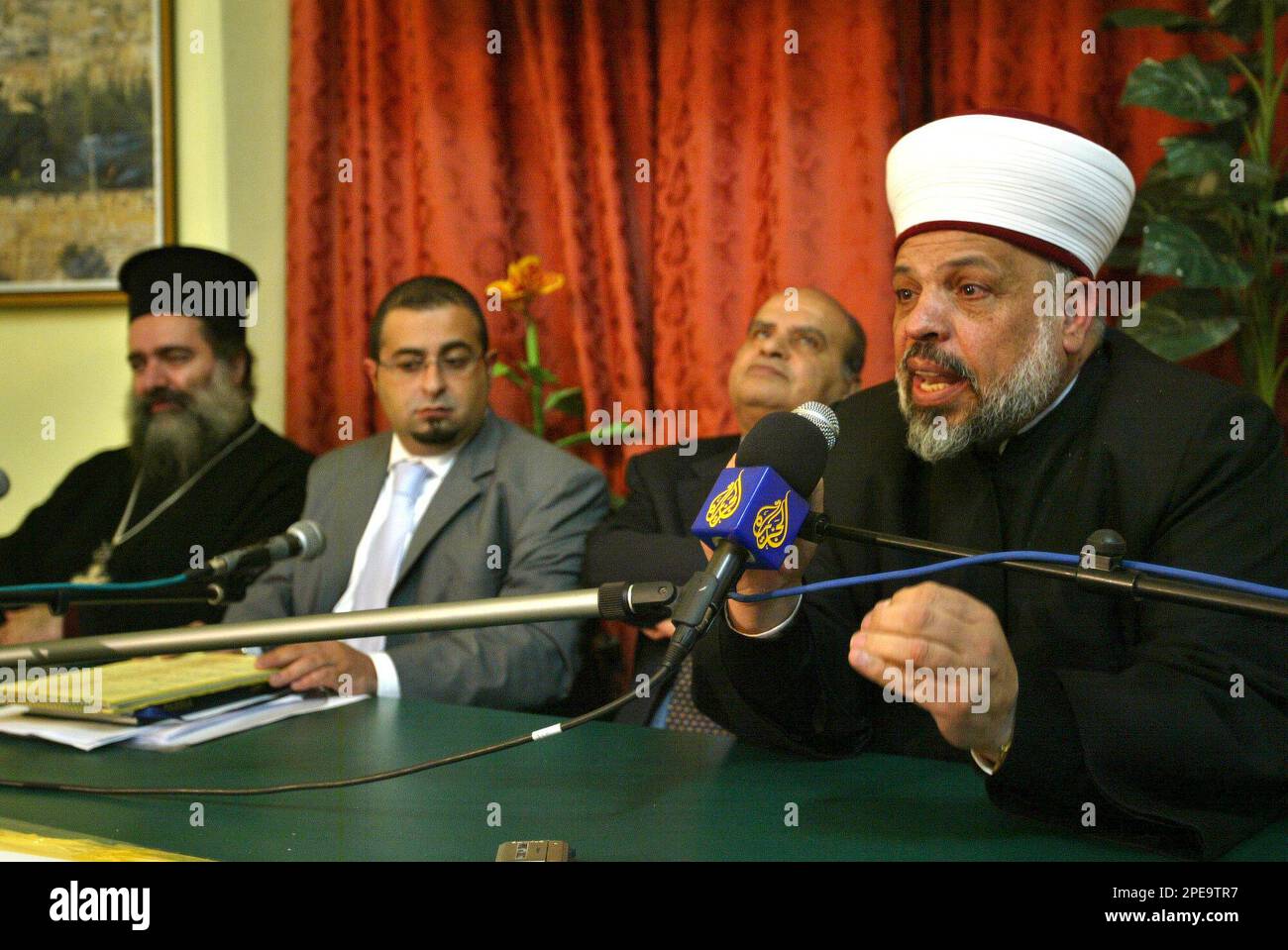 Muslim Cleric Tayser Tamimi speaks, flanked, from right, by Dr. Emil ...