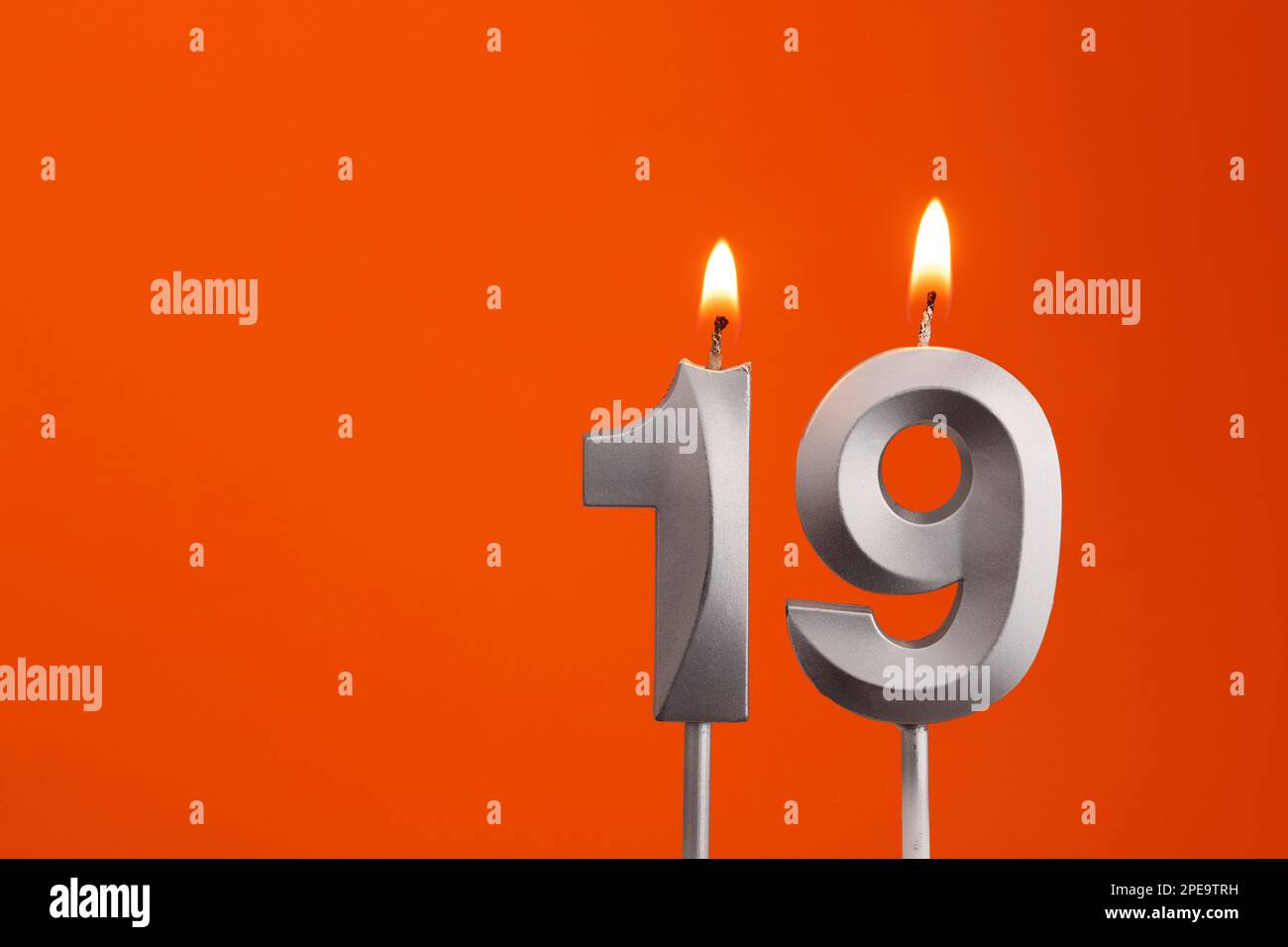 Number 19 - Silver Anniversary candle on orange background Stock Photo ...