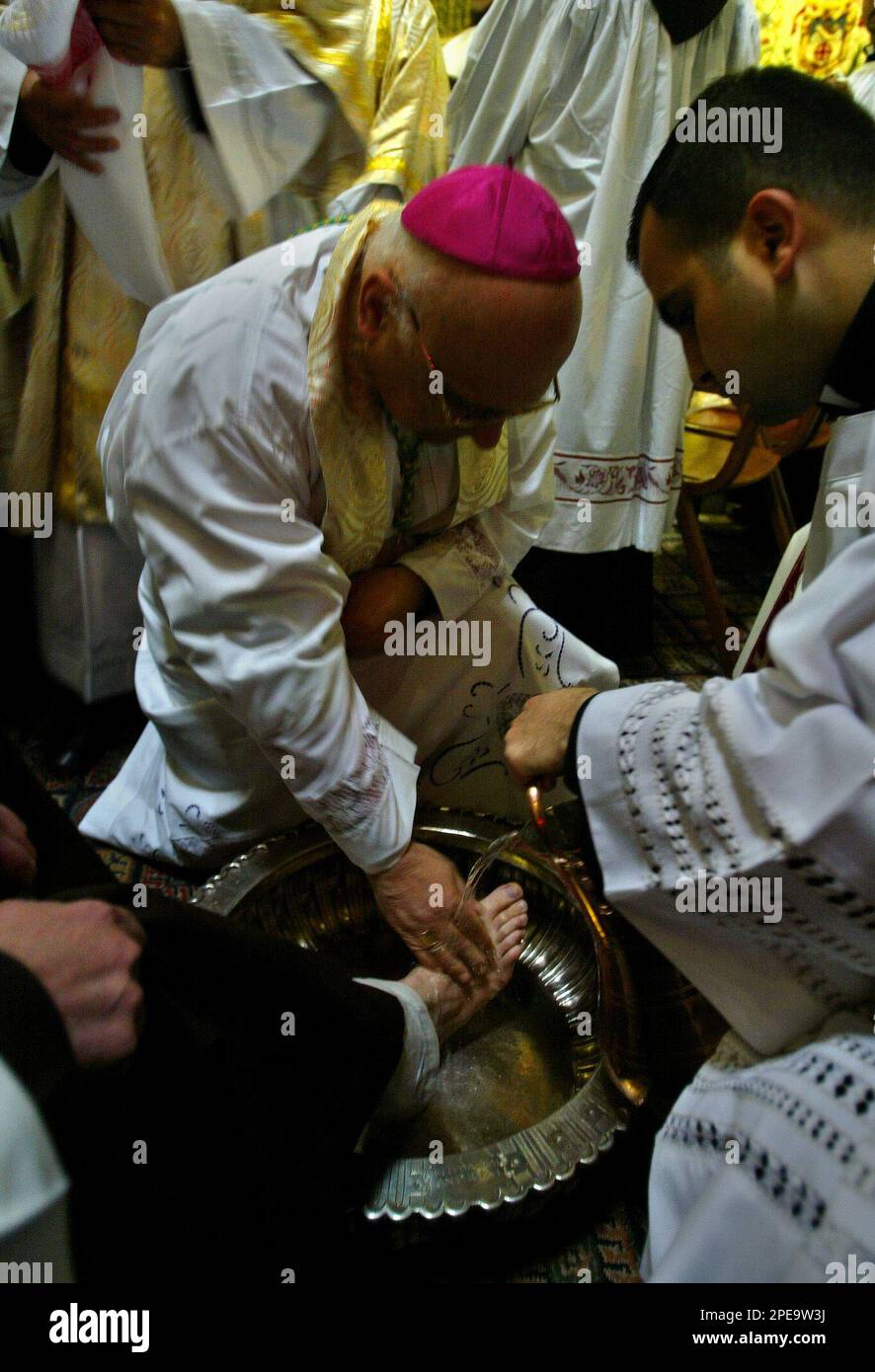 Michel Sabbah, the Latin Patriarch of Jerusalem, center, washes the ...