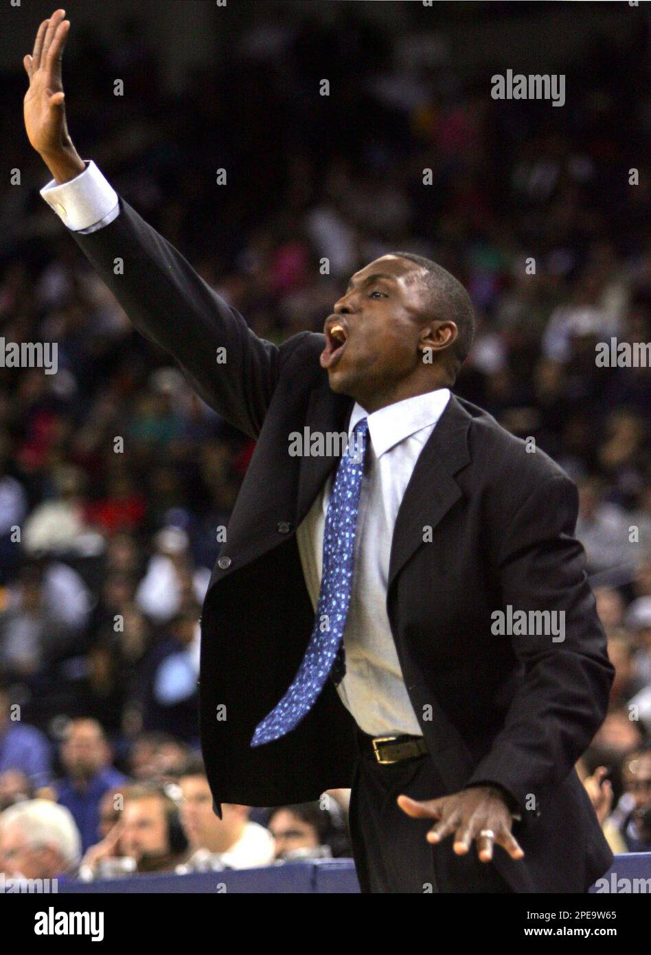 Dallas Mavericks head coach Avery Johnson instructs his team from the ...