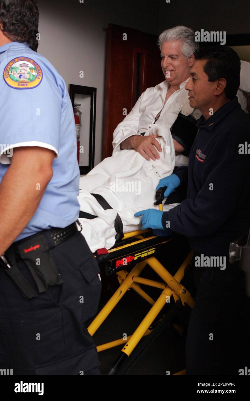 Brian Oxman, defense attorney for Michael Jackson, is wheeled from the ...