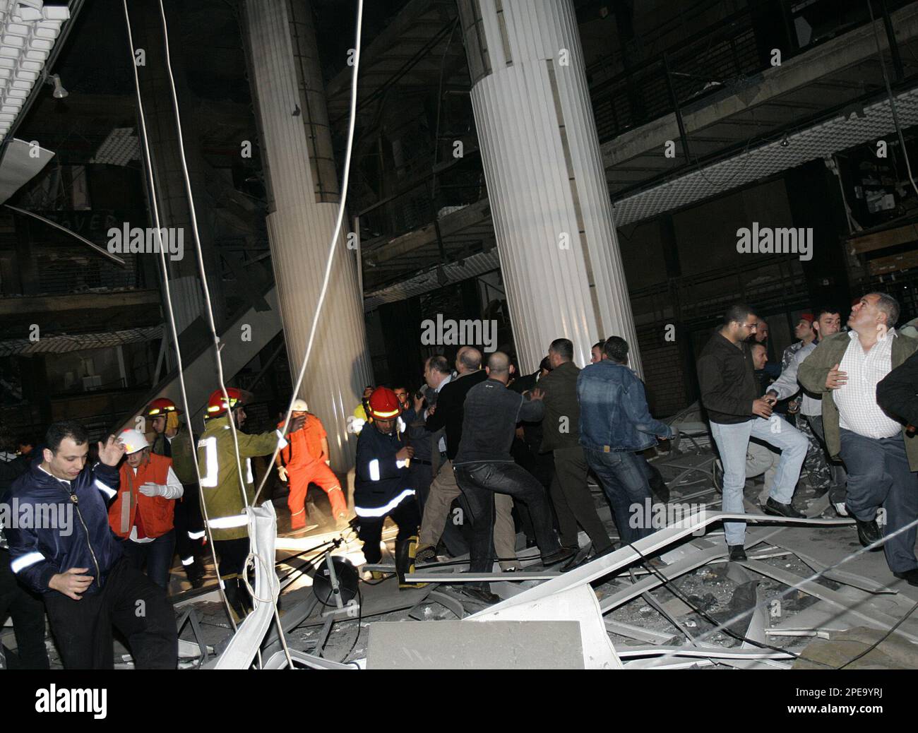 Lebanese investigaters and rescue teams run after a roof started ...